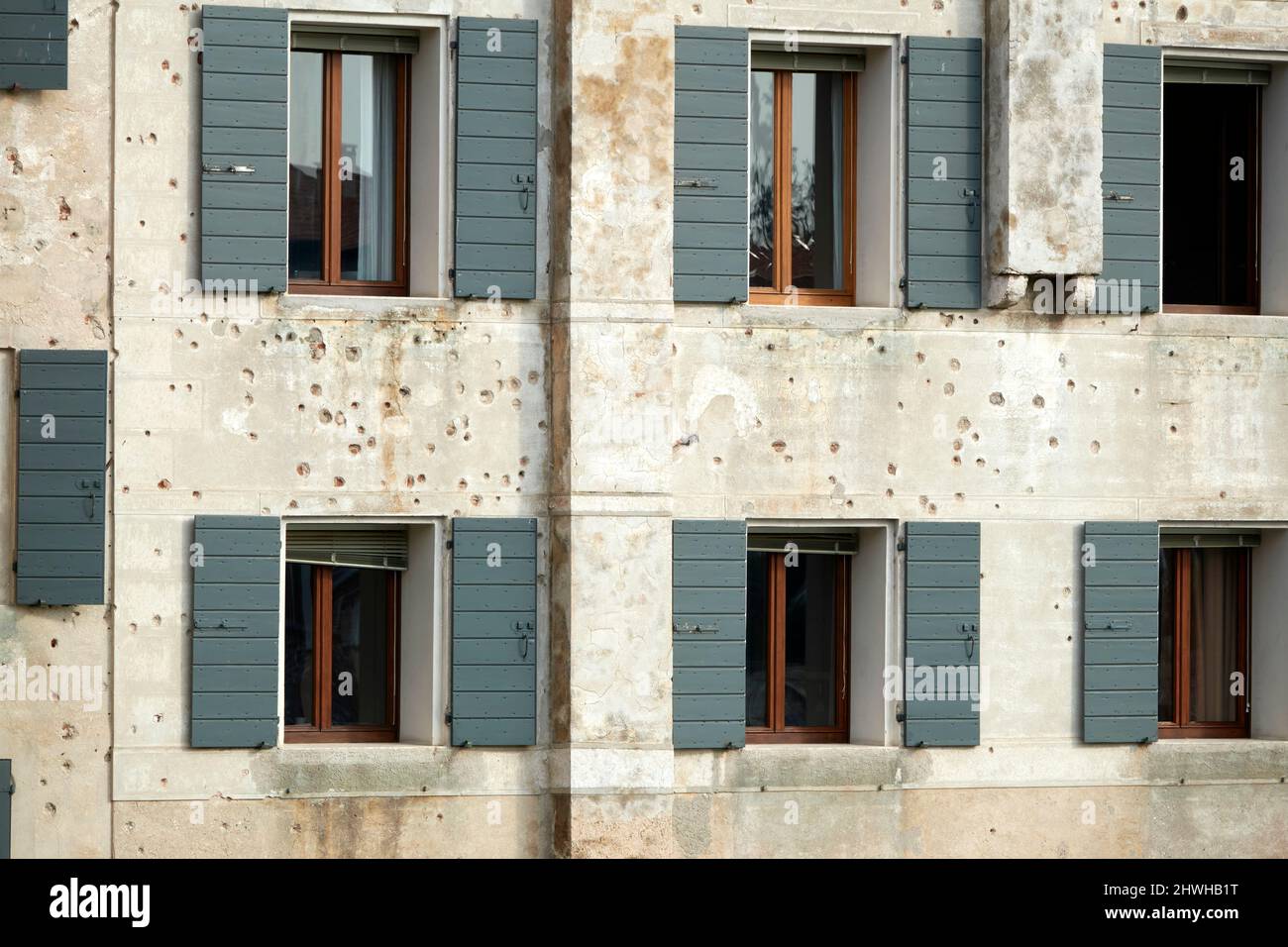Bullet holes in a wall made during hostilities Stock Photo - Alamy