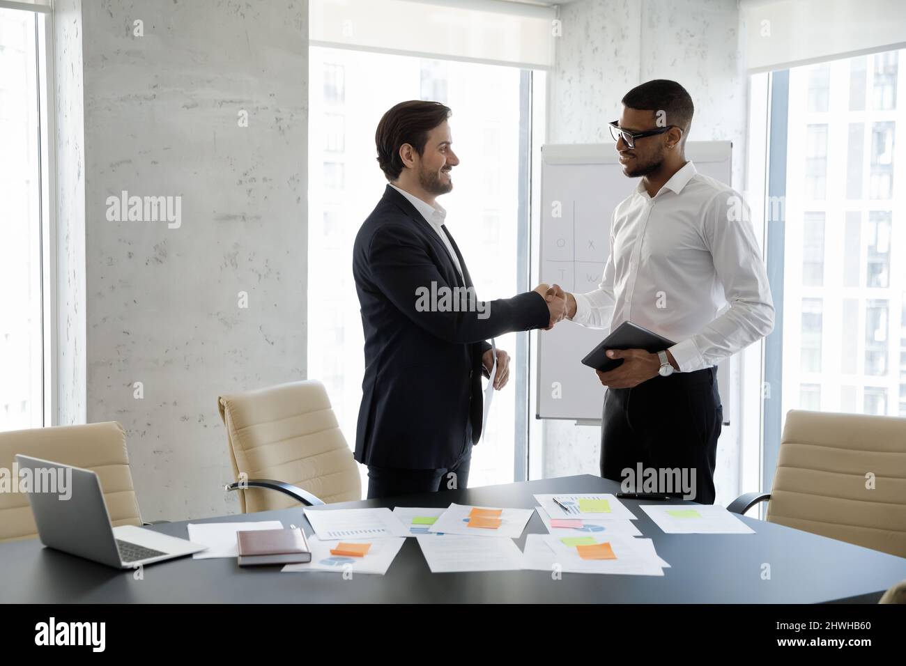 Two diverse multiracial businessmen discuss hi-res stock photography ...