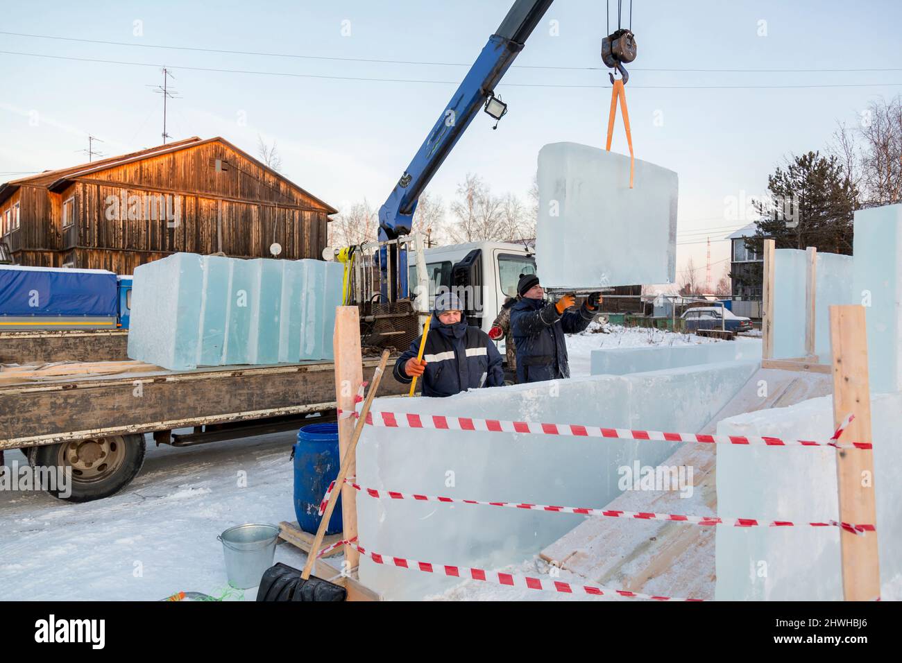 Installers adjust and install another ice block to the overall ...