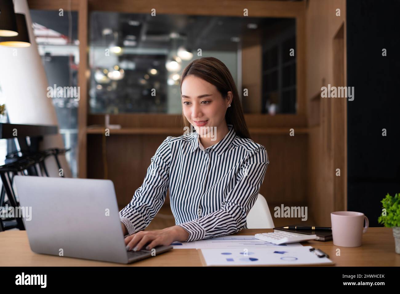 Business woman using laptop computer at office, account or saving money ...