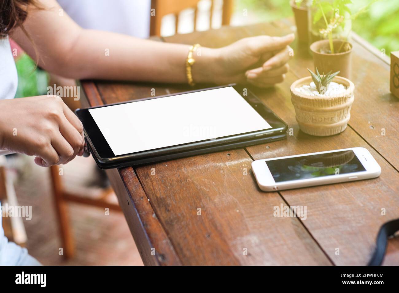 Hand of women use tablet computer while sitting in coffee shop, Blank ...