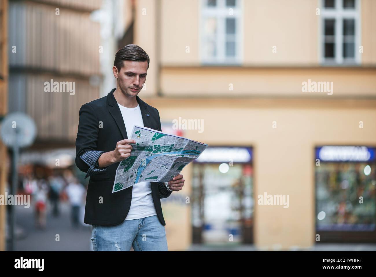 Young man searching for place of destination. Caucasian tourist looking ...