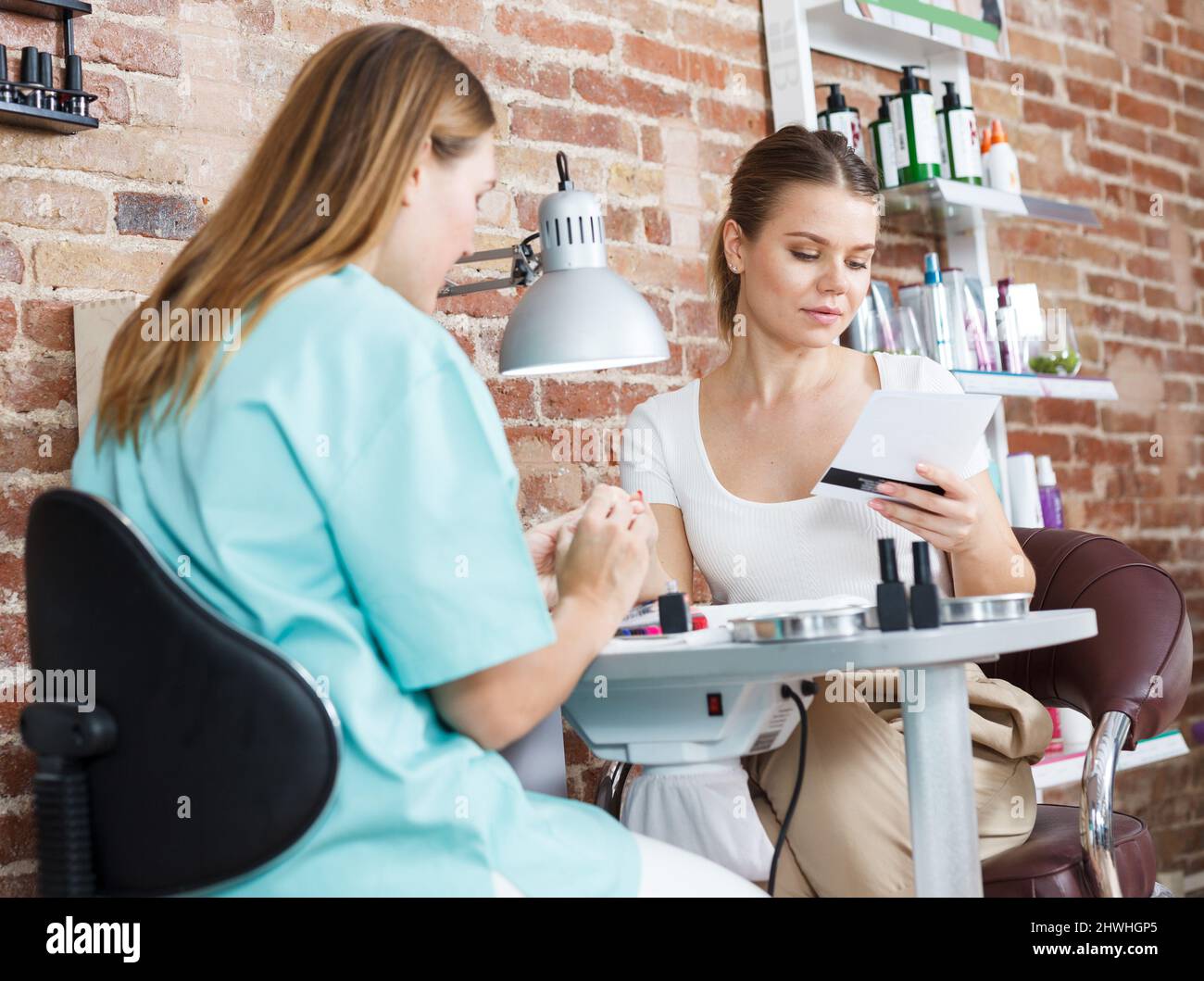 Unhappy manicure girl doing healthy manicure in nail salon Stock Photo ...
