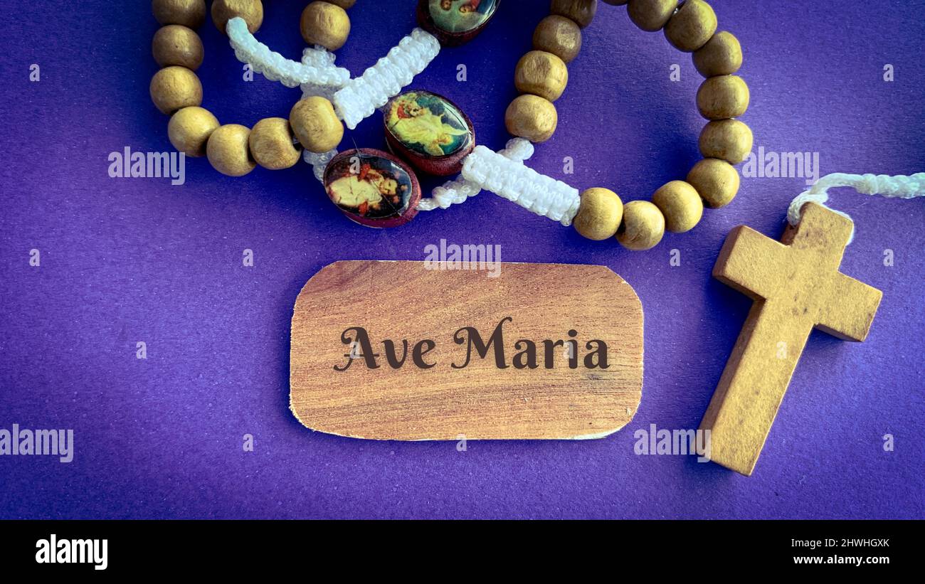 Top view of text - Ave Maria with purple and Holy Rosary background ...