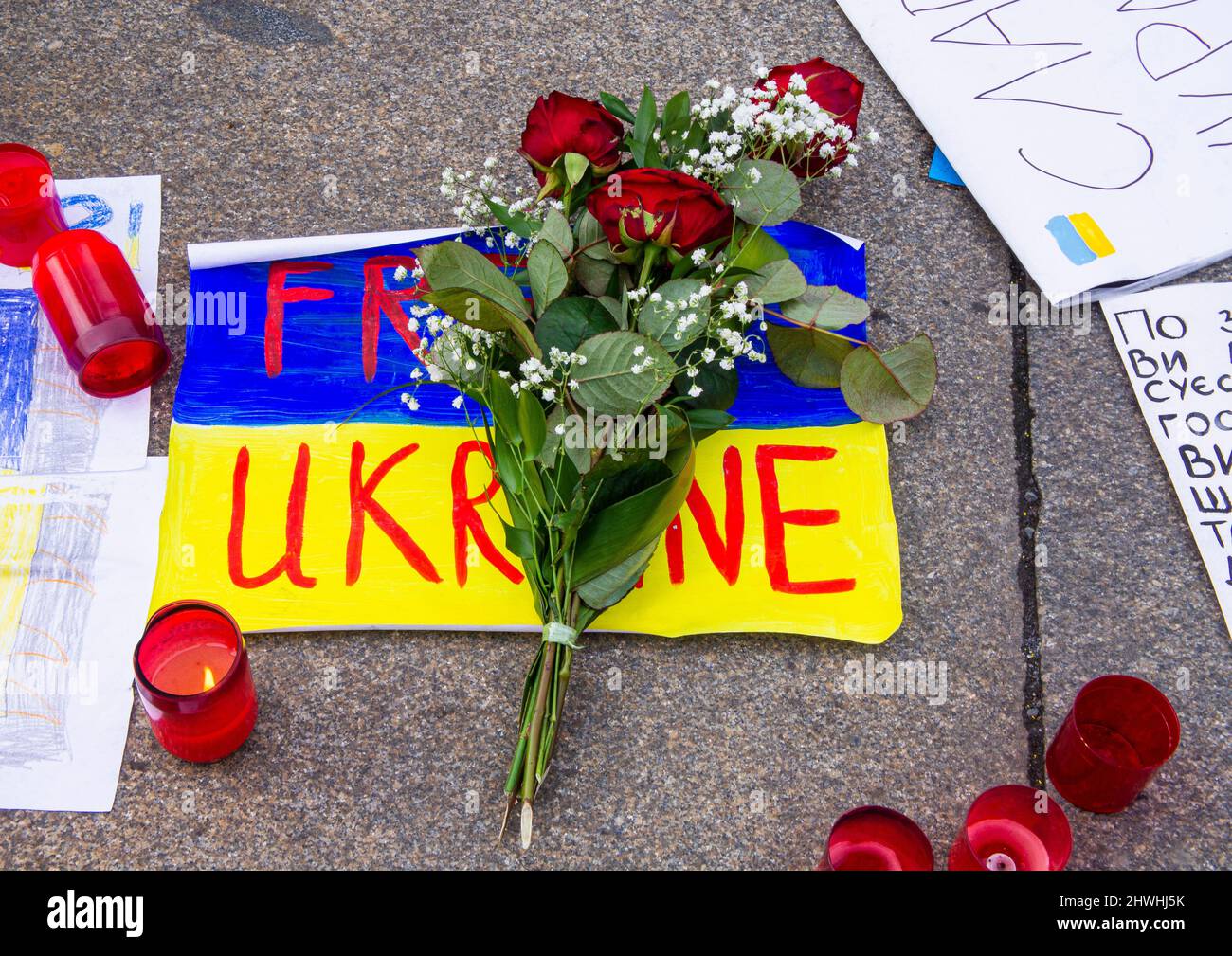 The bouquet, candles and messages in Ukrainian colours to show support ...