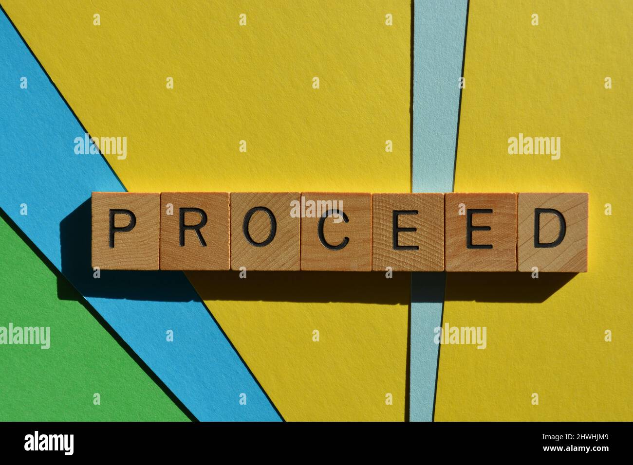 Proceed, word in wooden alphabet letters isolated on colourful ...