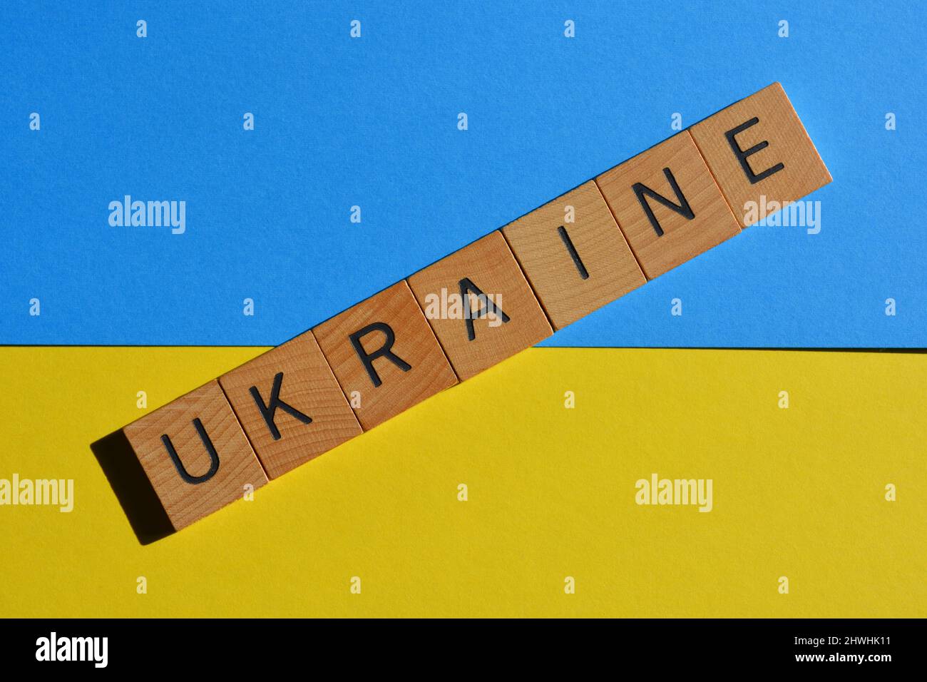 Ukraine, word in wooden alphabet letters isolated on blue and yellow ...
