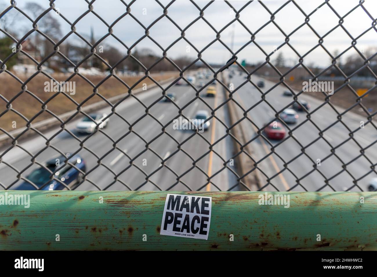 Make Peace sticker on fence on a bridge over the highway Stock Photo ...