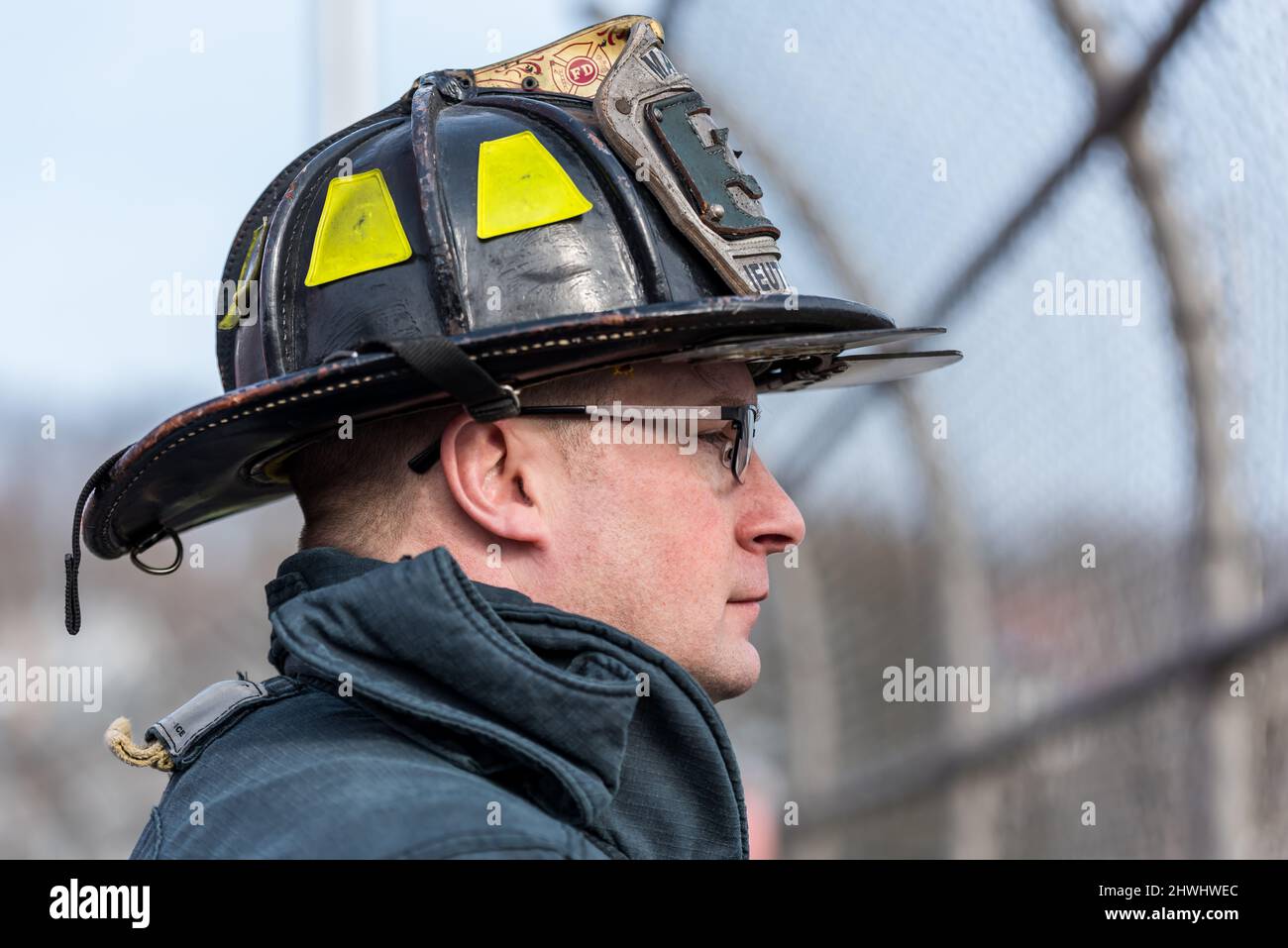 Portrait of a firefighter at the procession honoring Mass State Trooper ...