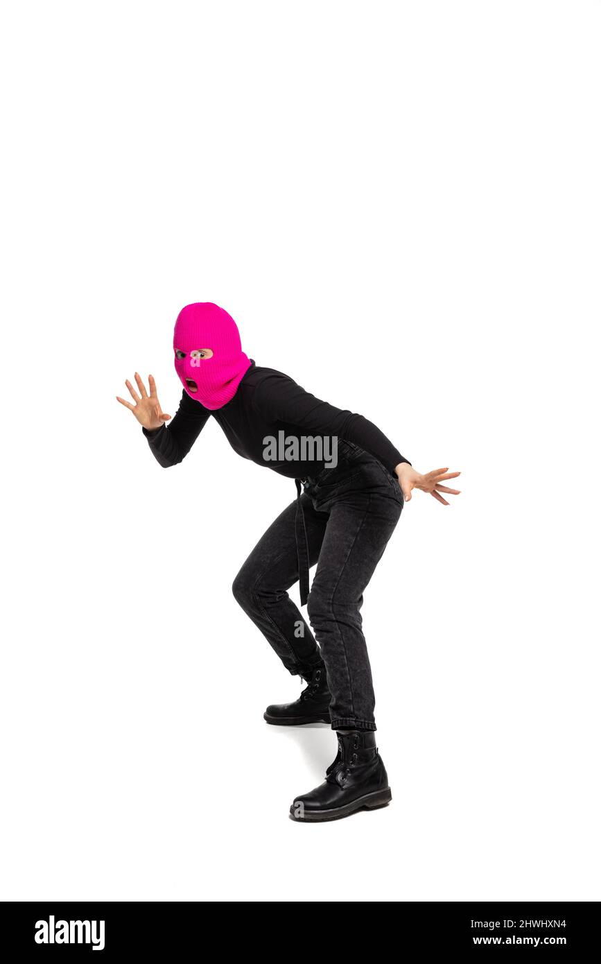 Portrait of young anonymous person wearing black outfit and balaclava ...