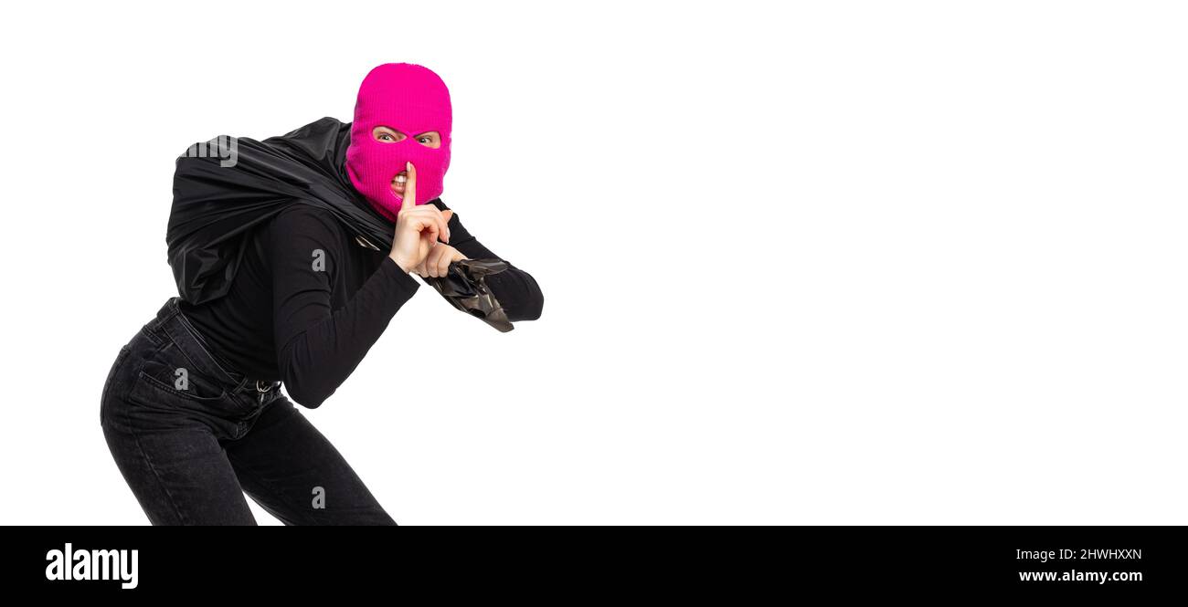 Portrait of young anonymous person wearing black outfit and balaclava ...