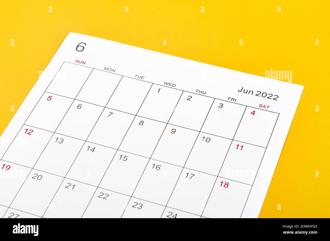 Close up June 2022 calendar sheet on yellow background Stock Photo - Alamy