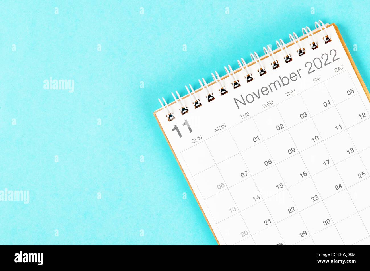 The November 2022 desk calendar on blue background with empty space ...