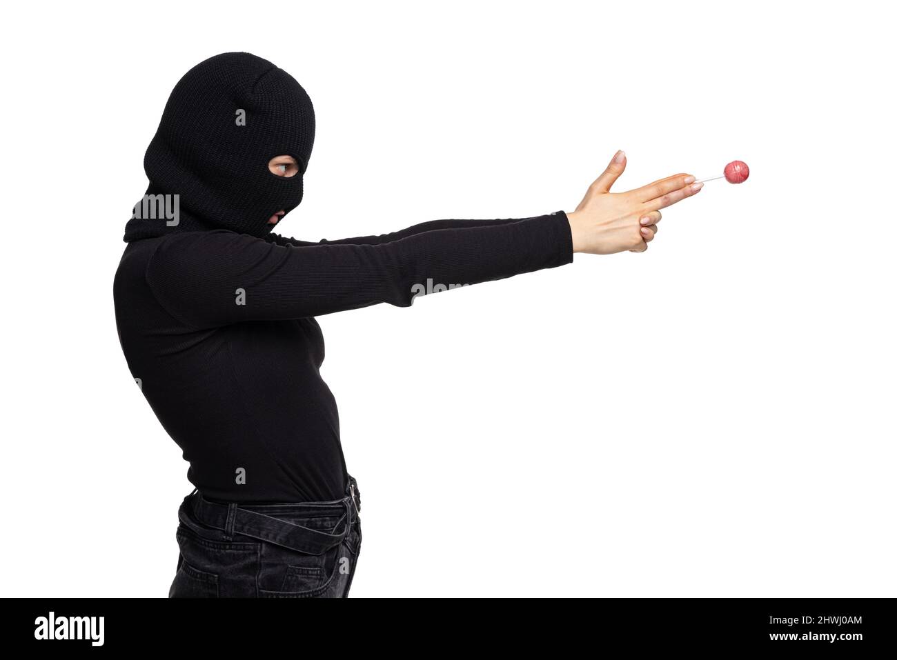 Portrait of young anonymous person wearing black outfit and balaclava ...