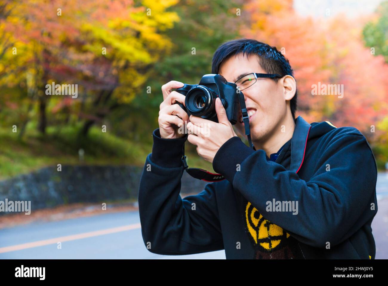 Photographer tourist man take photo of colourful tree leavesin Nikko ...