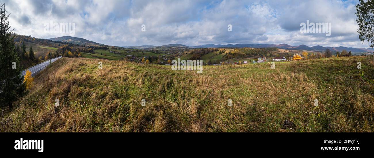 Hazy and overcast Carpathian Mountains and highway on mountain pass ...