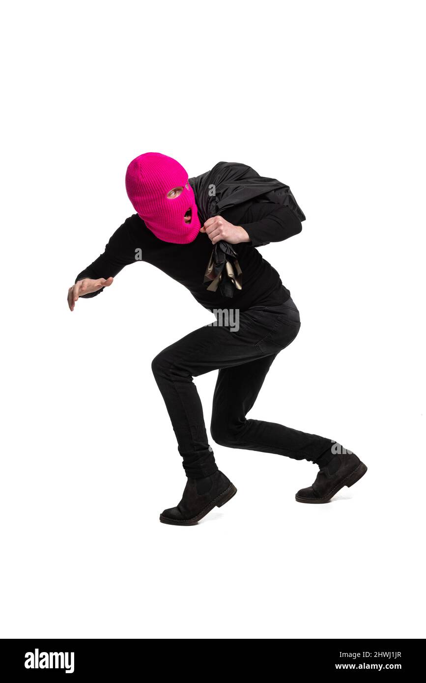 Portrait of young anonymous person wearing black outfit and balaclava ...