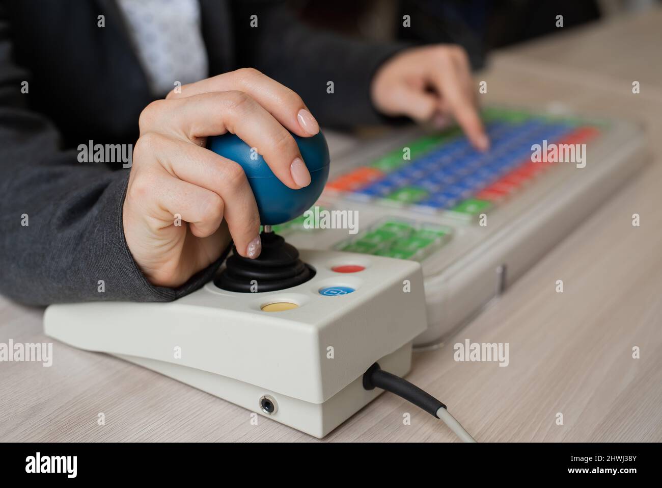 Woman with cerebral palsy works on a specialized computer mouse Stock ...