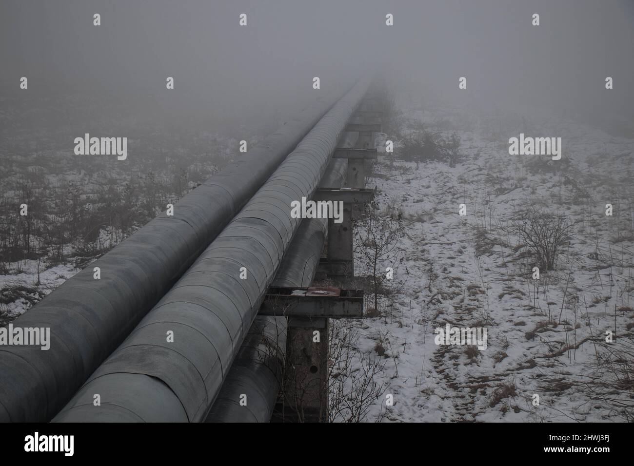 Industrial pipes in a foggy winter scene Stock Photo - Alamy