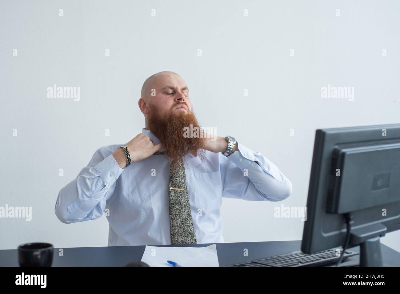 Problems for the office worker. A bald man in a white shirt sits at a ...