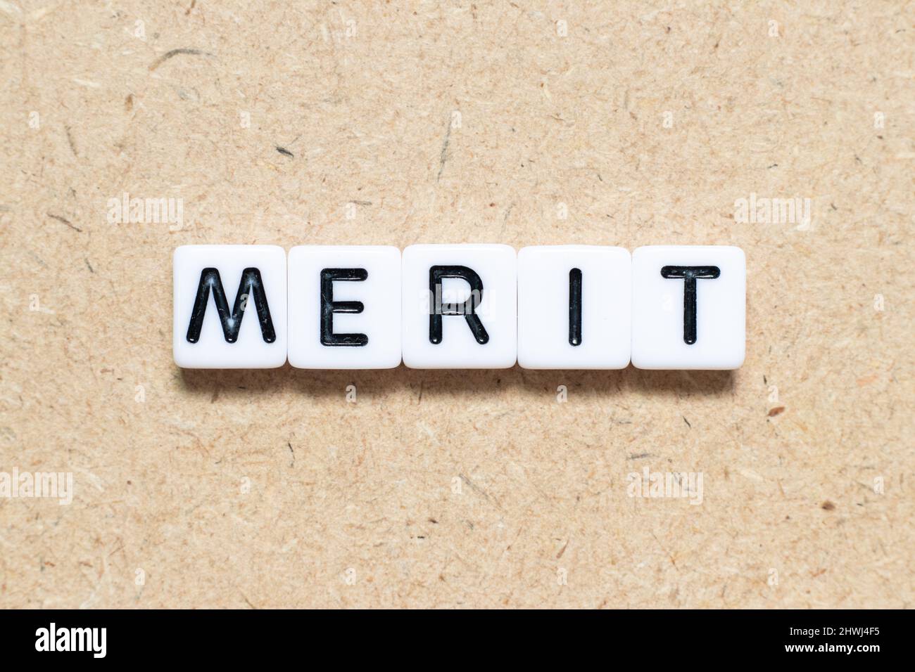 White tile alphabet letter with word merit on wood background Stock ...