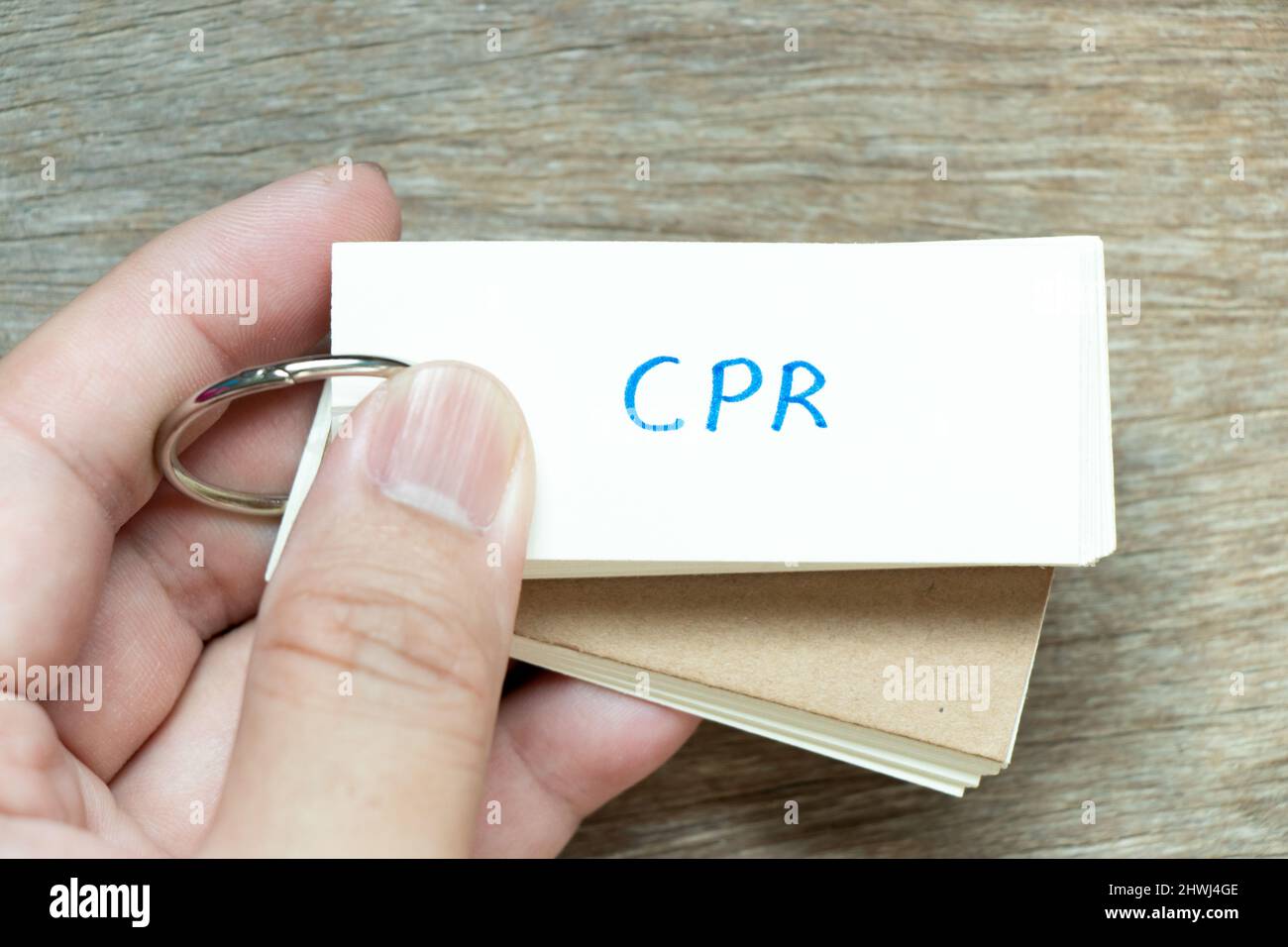 Man hold the flash card with handwriting word CPR (abbreviation of ...