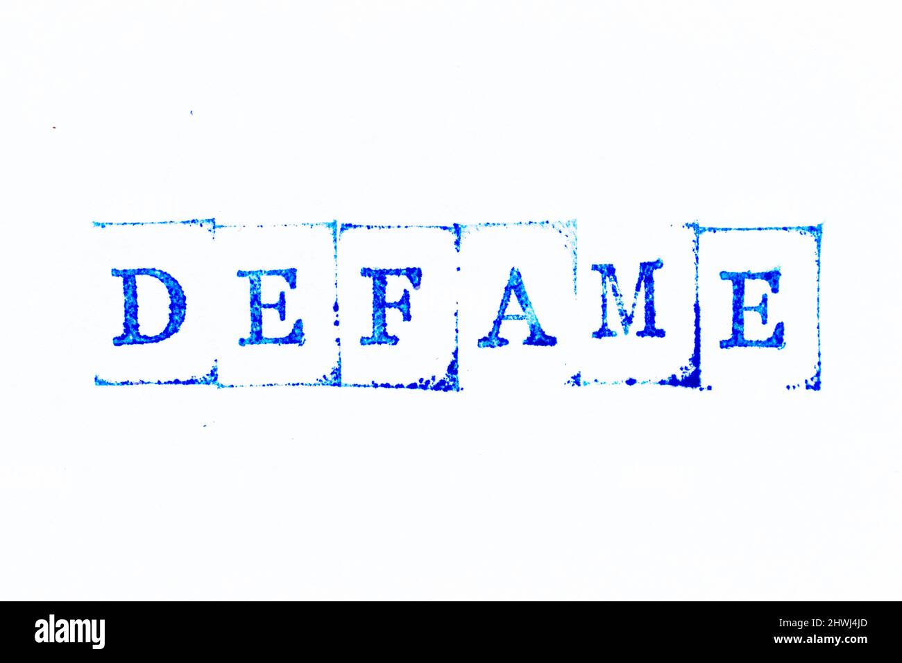Blue color ink rubber stamp in word defame on white paper background ...