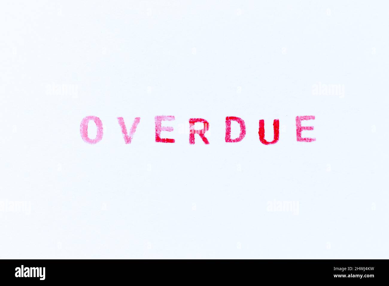 Red color ink rubber stamp in word overdue on white paper background ...
