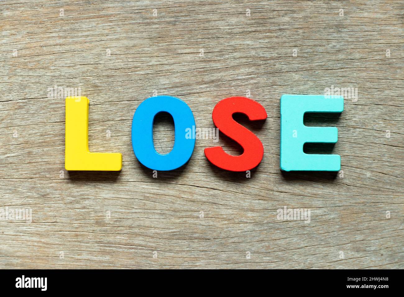 Color alphabet letter in word lose on wood background Stock Photo - Alamy