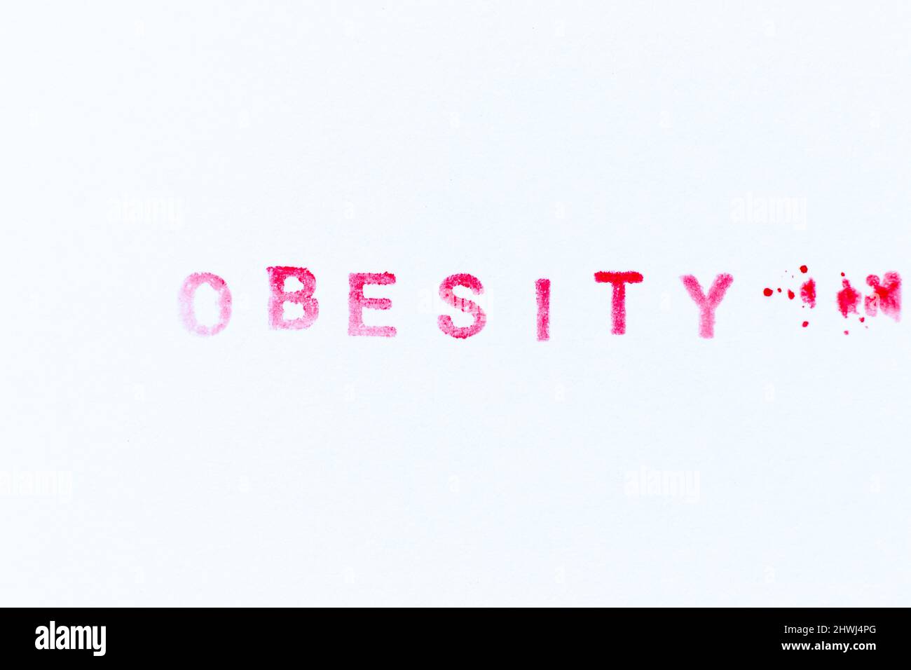 Red color ink rubber stamp in word obesity on white paper background ...