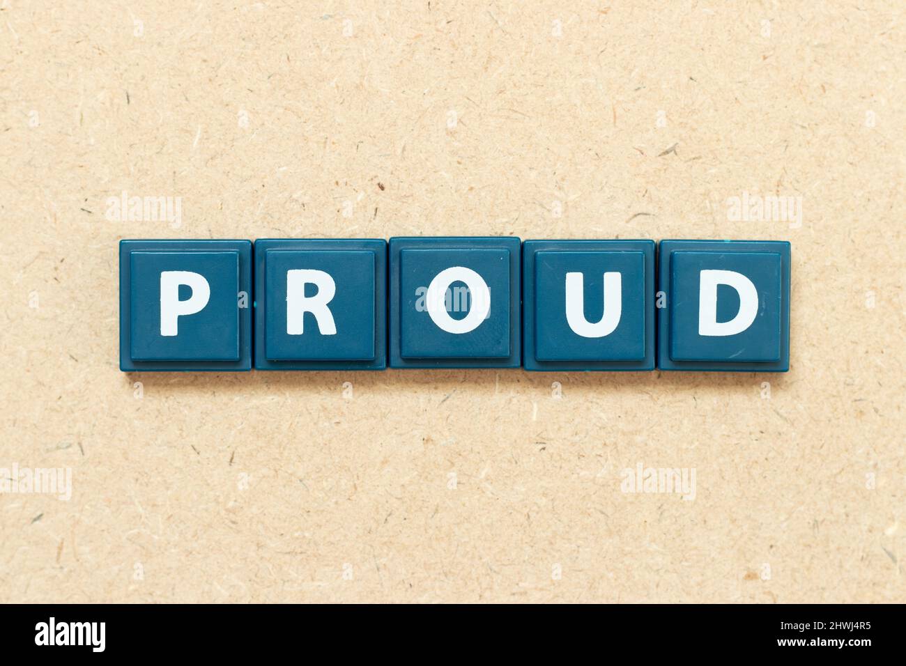 Tile alphabet letter in word proud on wood background Stock Photo - Alamy