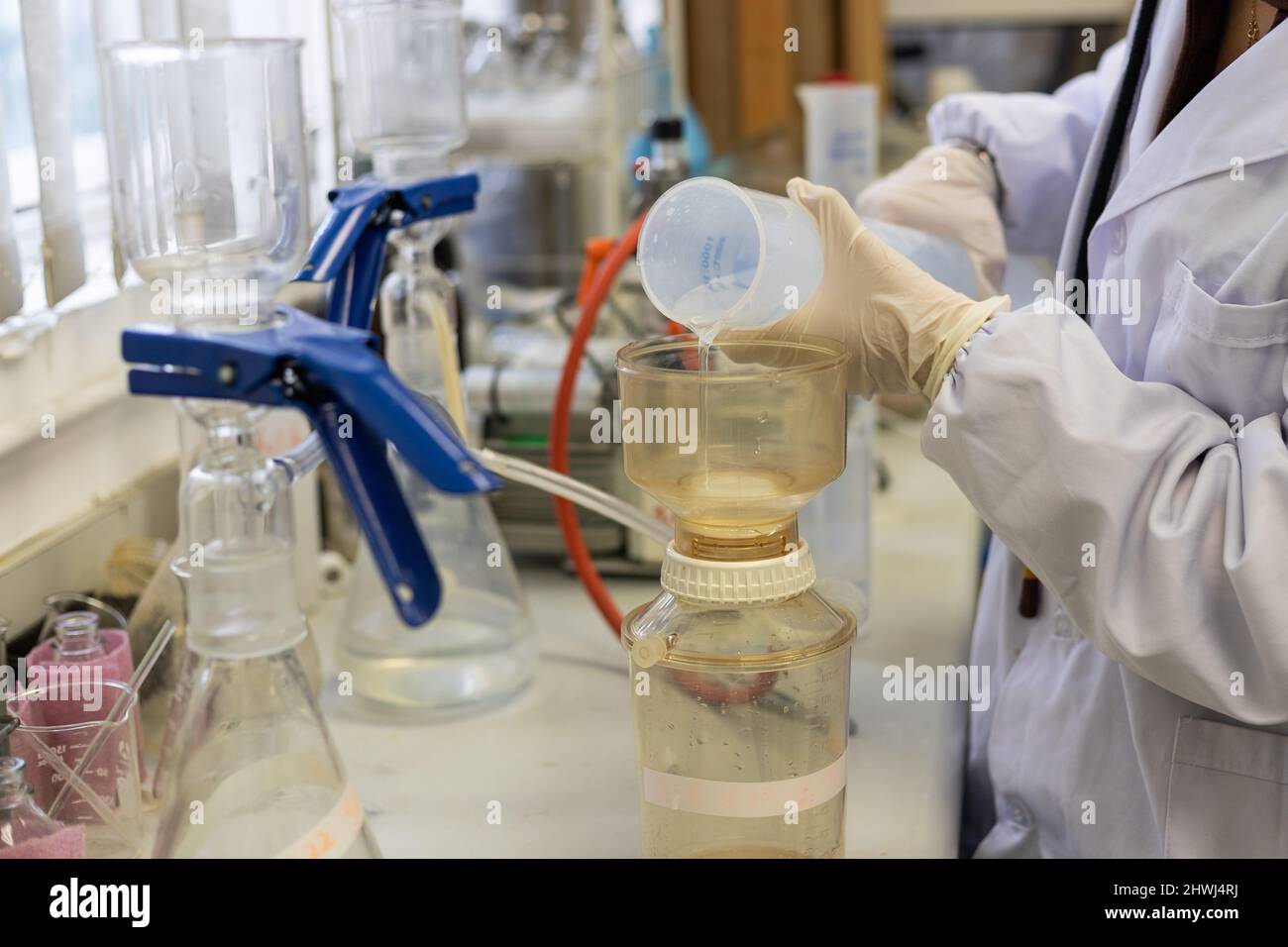 lady scientist filter water in laboratory before advanced chemical ...