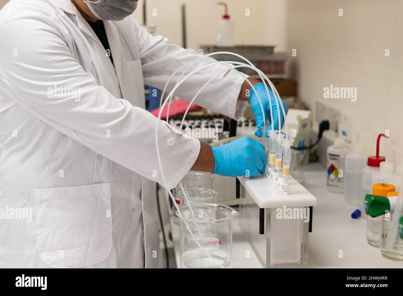 technicians and scientist extract antibiotics from water sample using ...