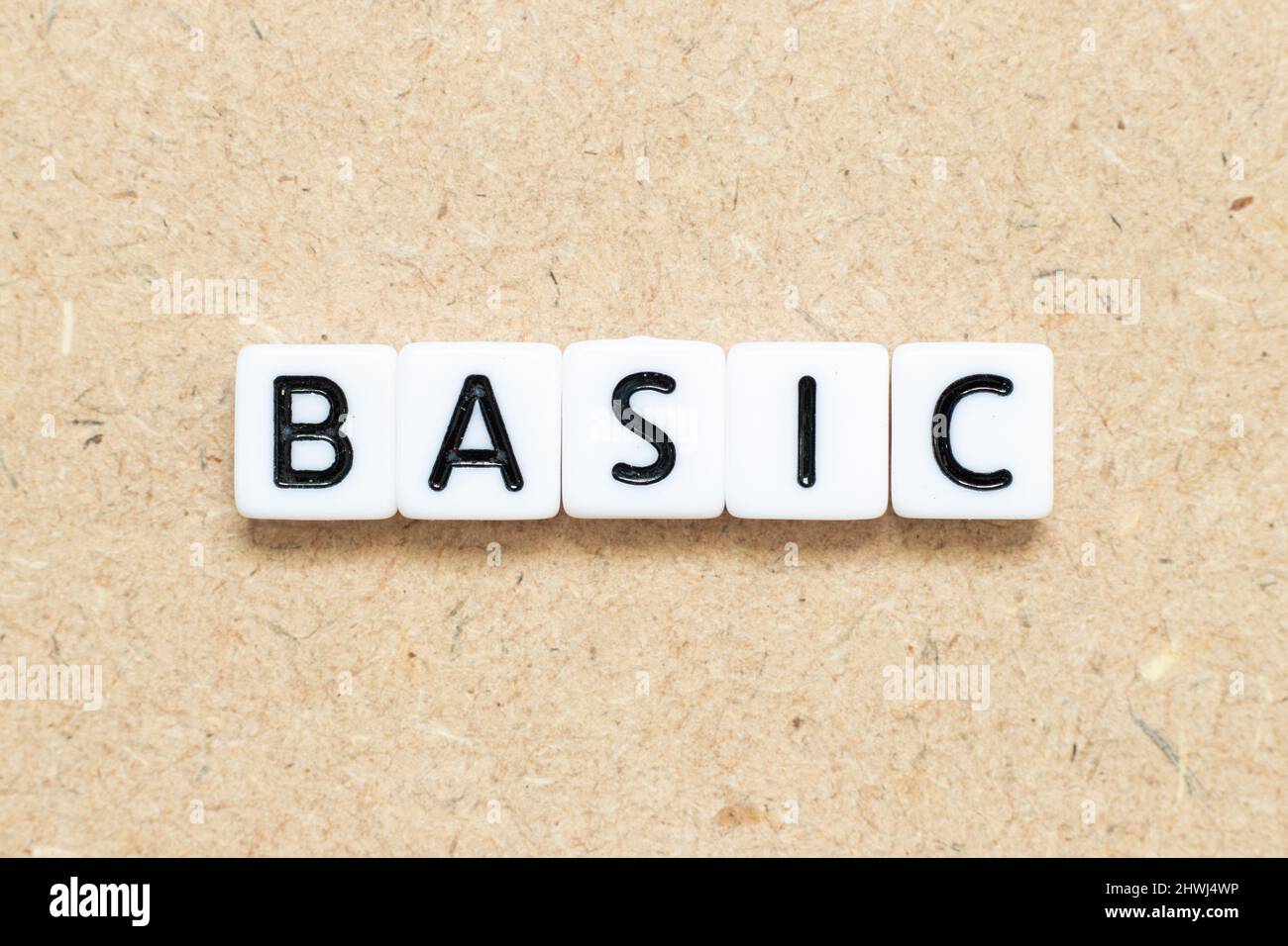 White tile alphabet letter with word basic on wood background Stock ...