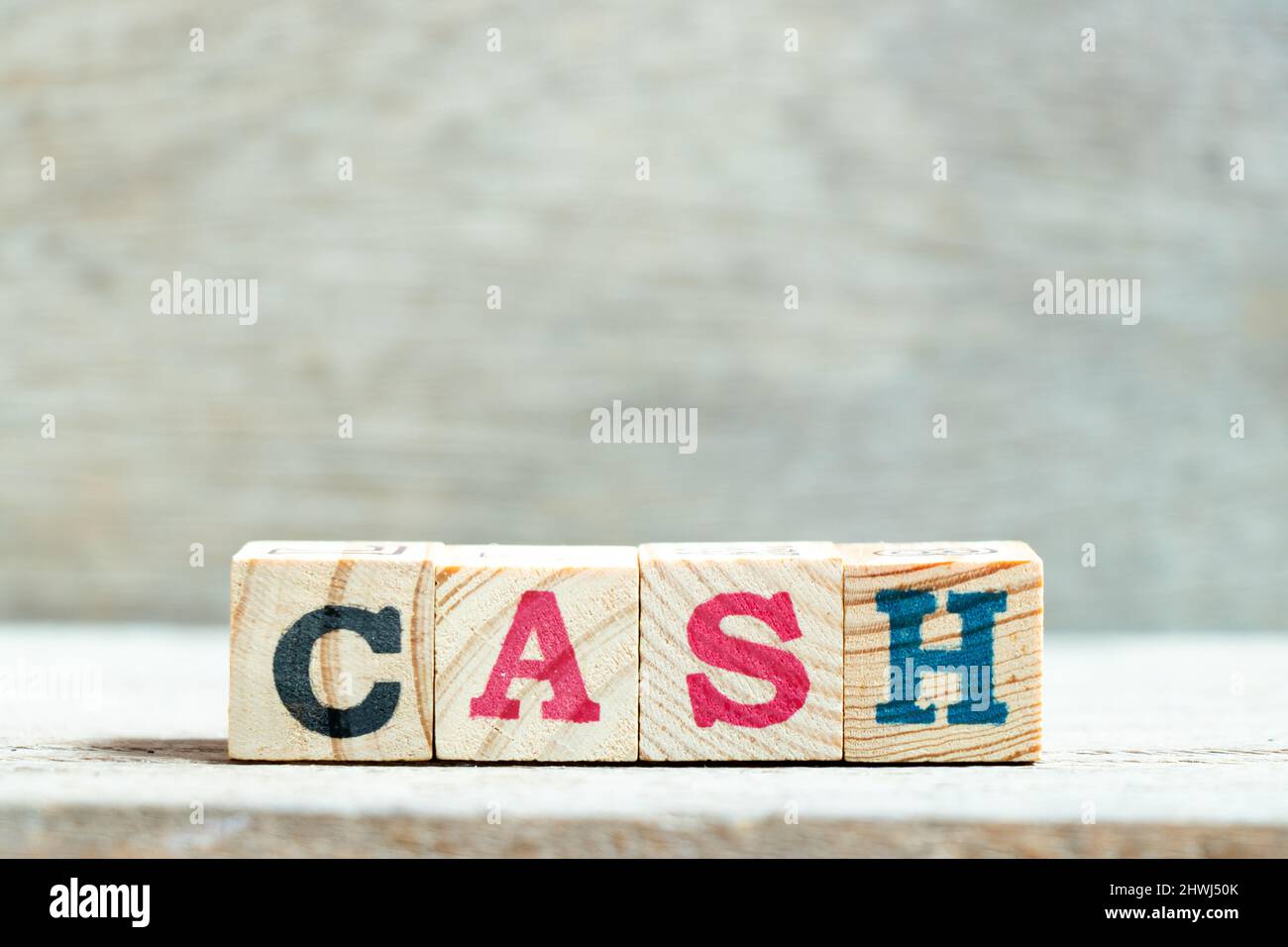 Alphabet letter block in word cash on wood background Stock Photo - Alamy