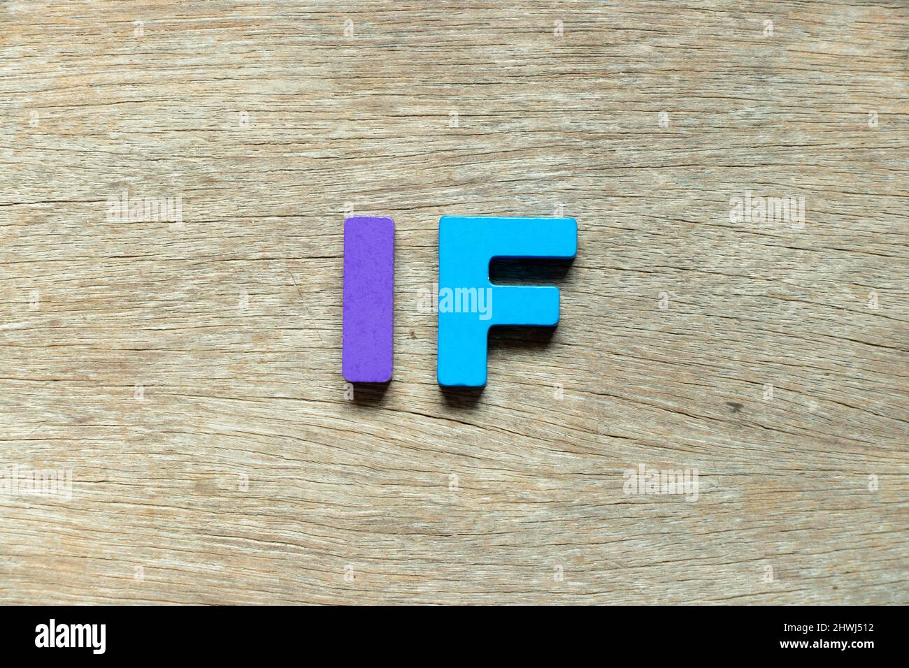 Color alphabet letter in word if on wood background Stock Photo - Alamy