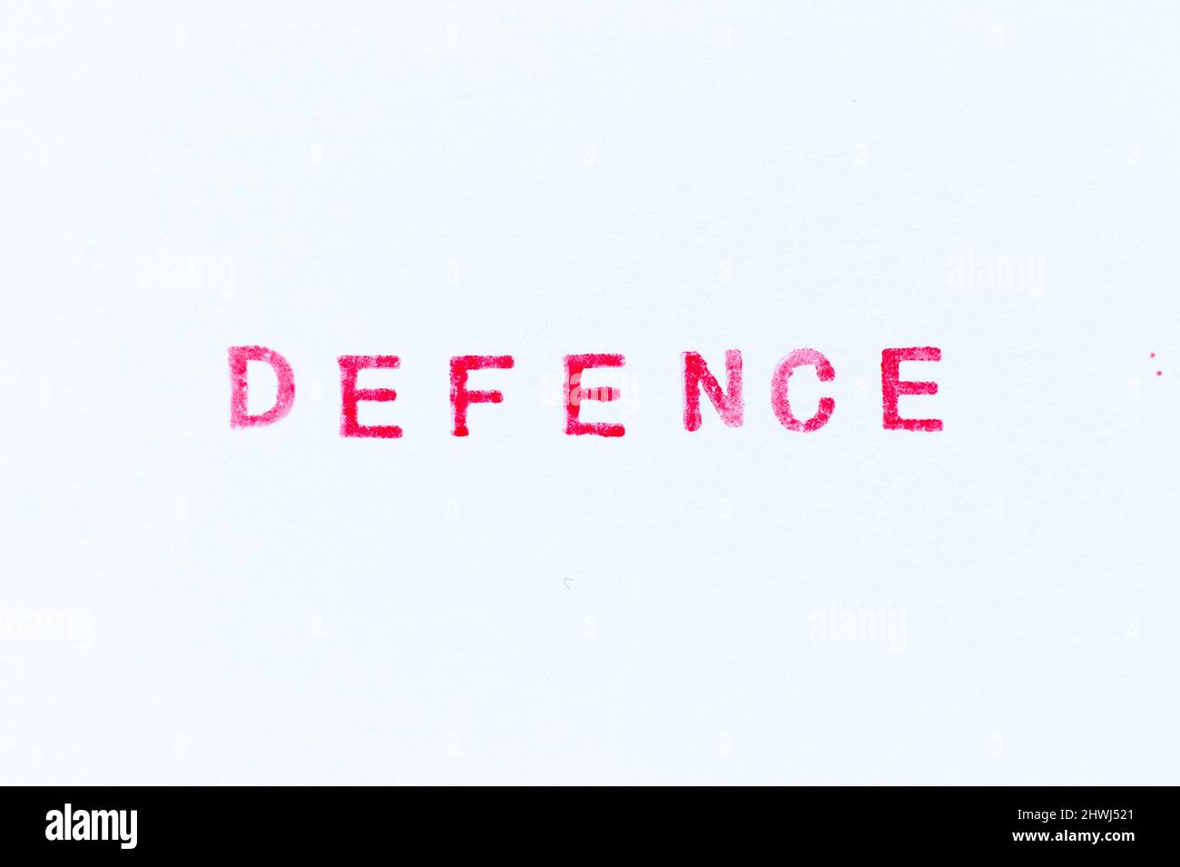 Red color ink rubber stamp in word defence on white paper background ...