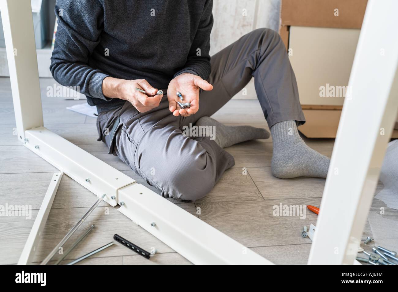 One man unknown caucasian male sitting on the floor at home Putting ...