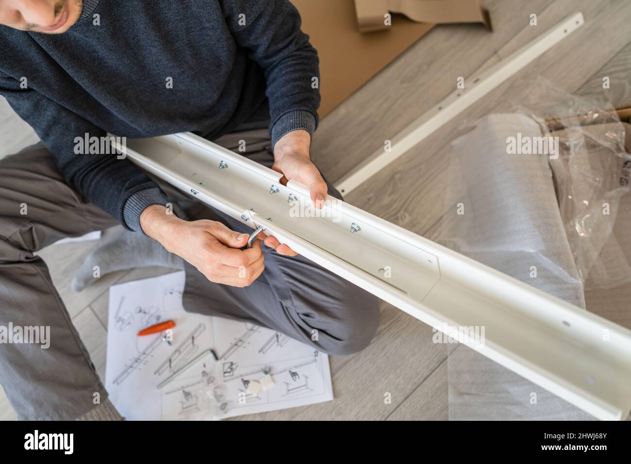 One man unknown caucasian male sitting on the floor at home Putting ...
