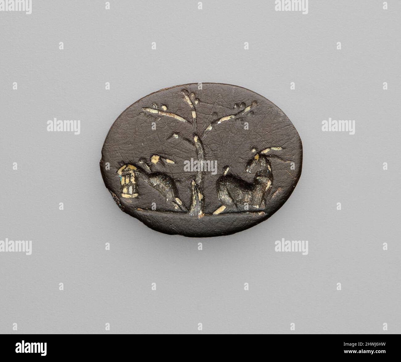 Carved intaglio with two animals flanking a tree Stock Photo - Alamy