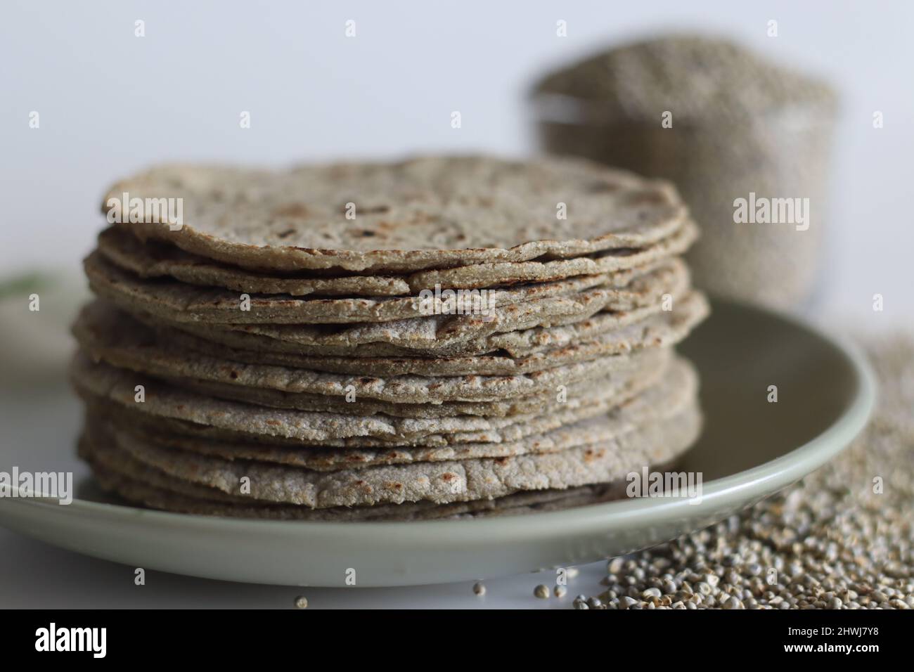 Soft flat bread made of pearl millet flour. Shot on white background ...