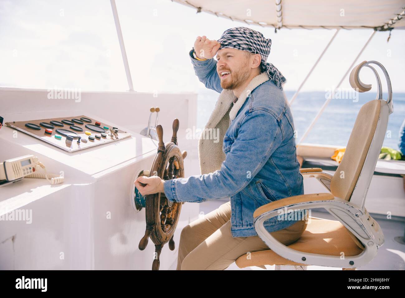 Tourist man on keffiyeh or arabic shawl driver captain of white luxury ...