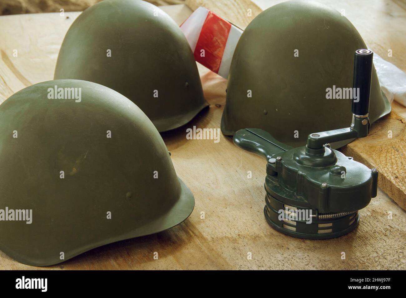 War. Military ammunition. Military helmets and hand siren. manual siren ...