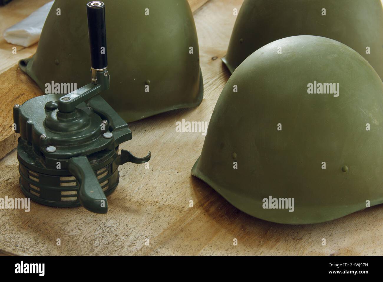 War. Military ammunition. Military helmets and hand siren. manual siren ...