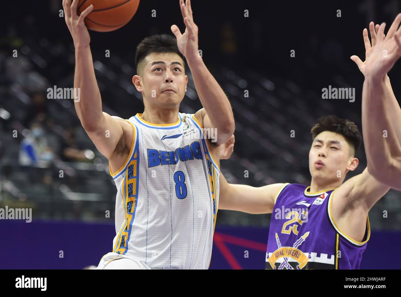 Shunde. 6th Mar, 2022. Fang Shuo(L) of Beijing Ducks goes for lay-up ...