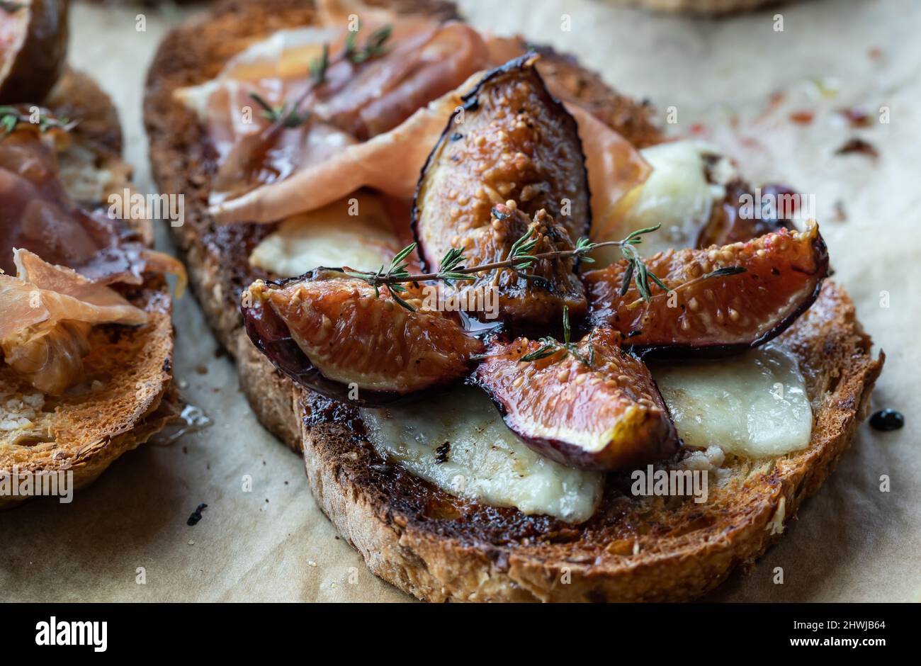 Close up of a toasted fig and prosciutto tartine ready for eating Stock ...