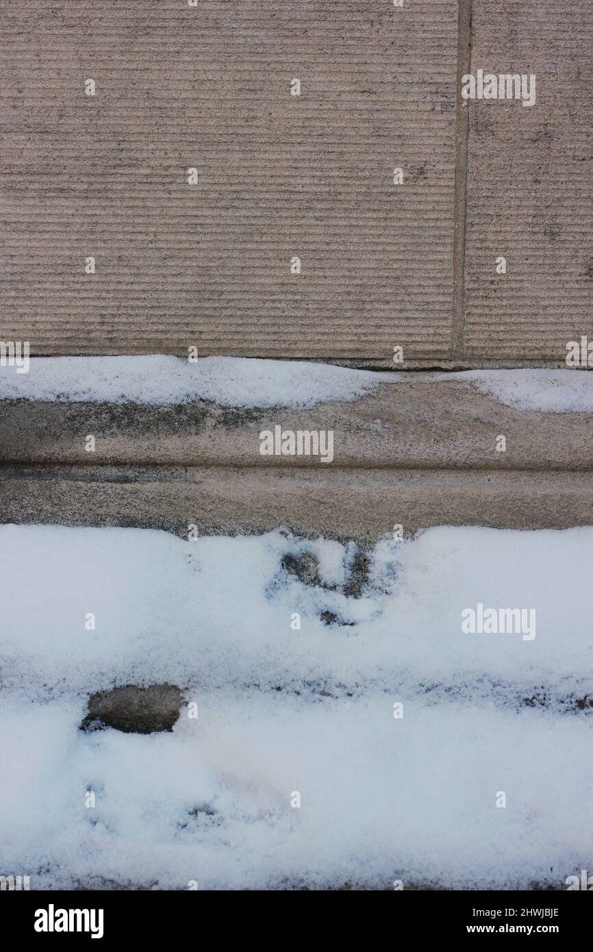 A detail of a Gothic building stone wall with fresh snow covering the ...