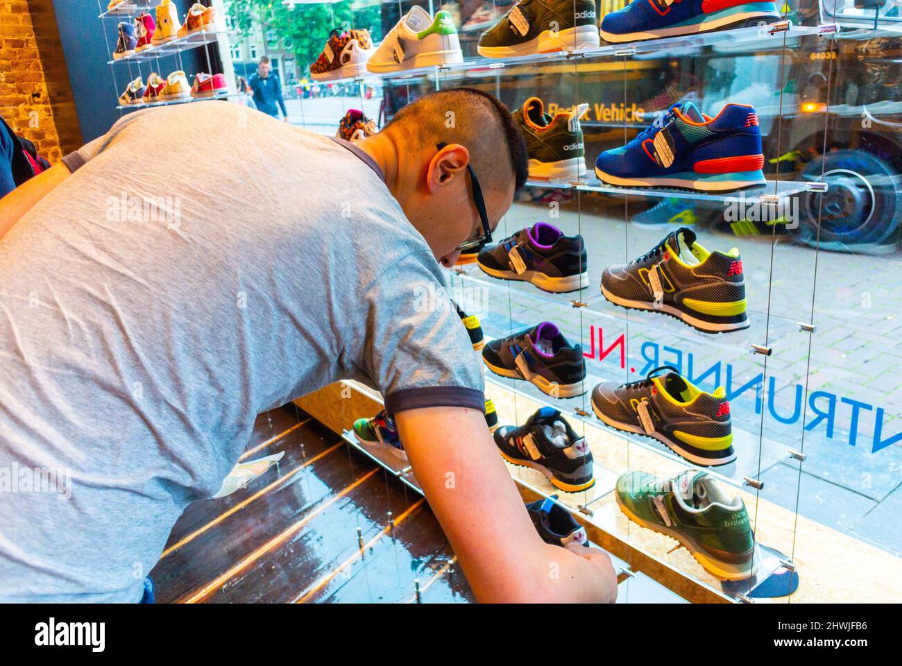 Amsterdam, Holland, Chinese Man Shopping for « New Balance » inside ...