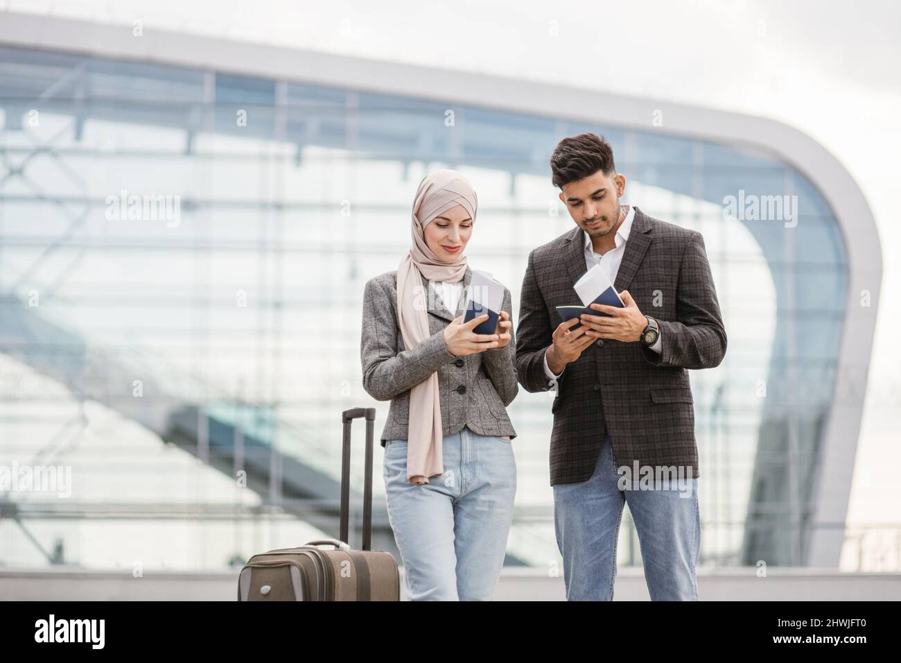 Portrait of happy muslim couple, woman in hijab and manin jacket ...