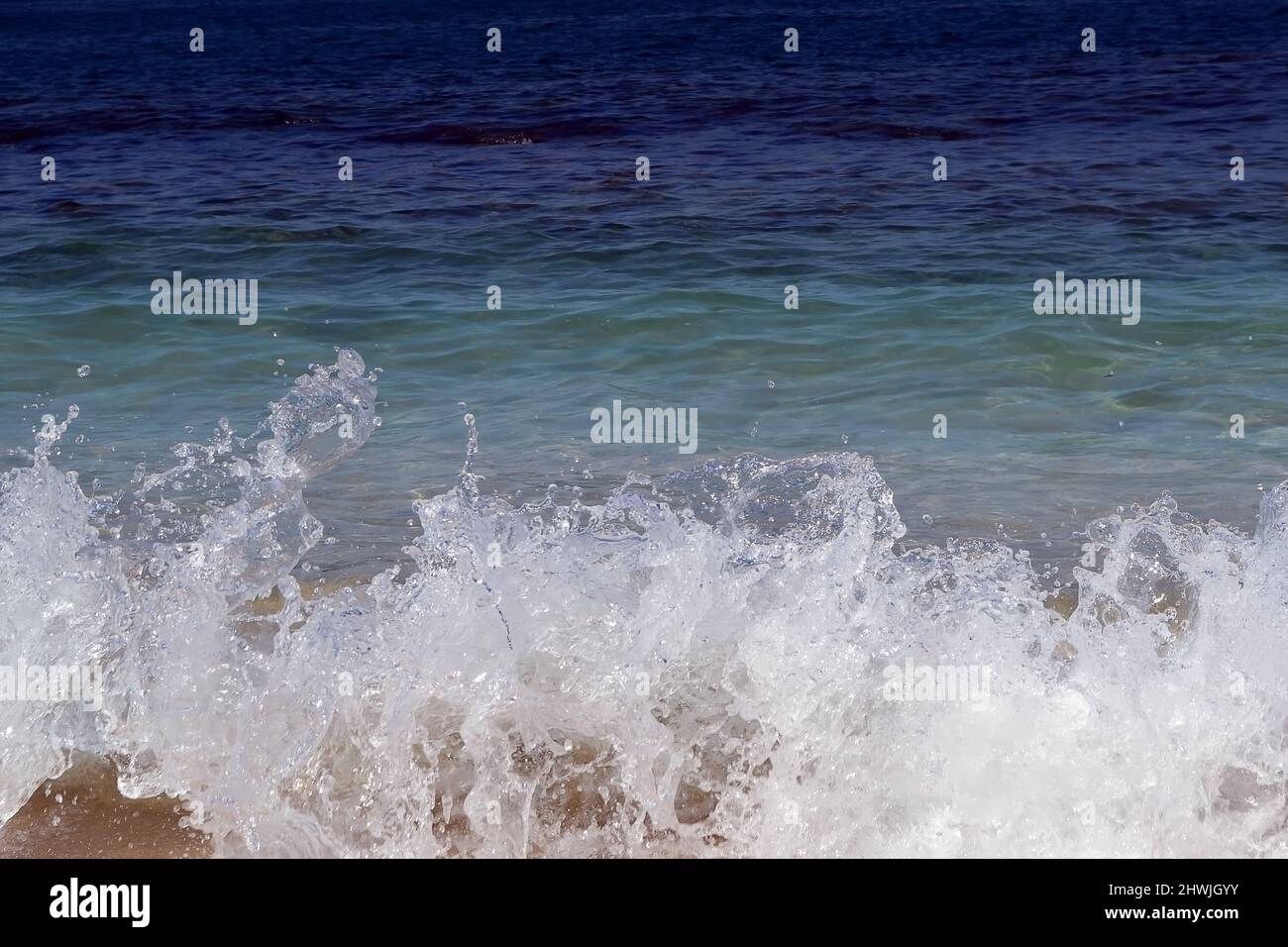 Ocean splashing waves with sandy beach. Background. Copy space Stock ...